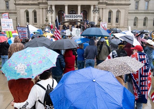 Hundreds of protesters, some armed storm Michigan Capitol seeking end ...
